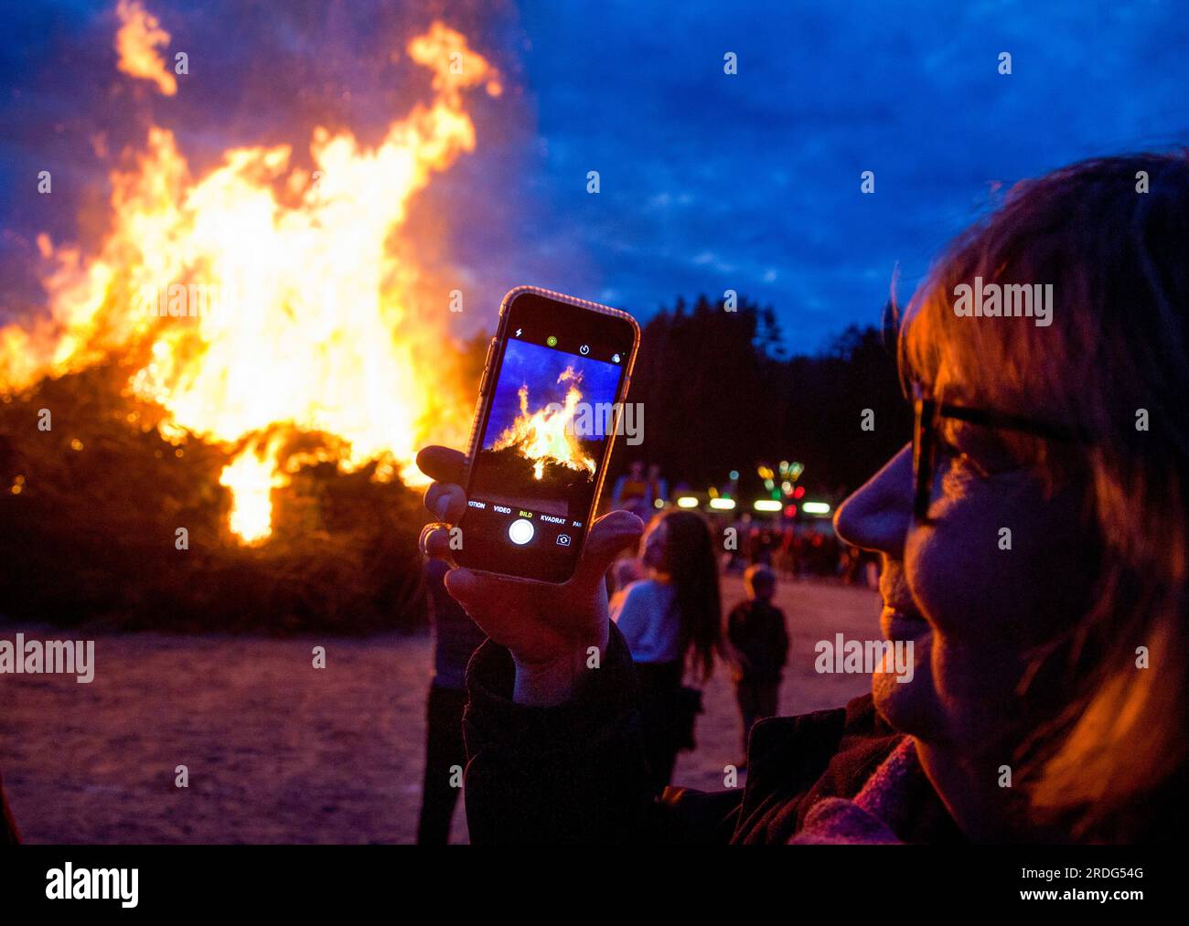 WALPURGIS BONFIRES in Sweden spectators take photos with their mobile ...