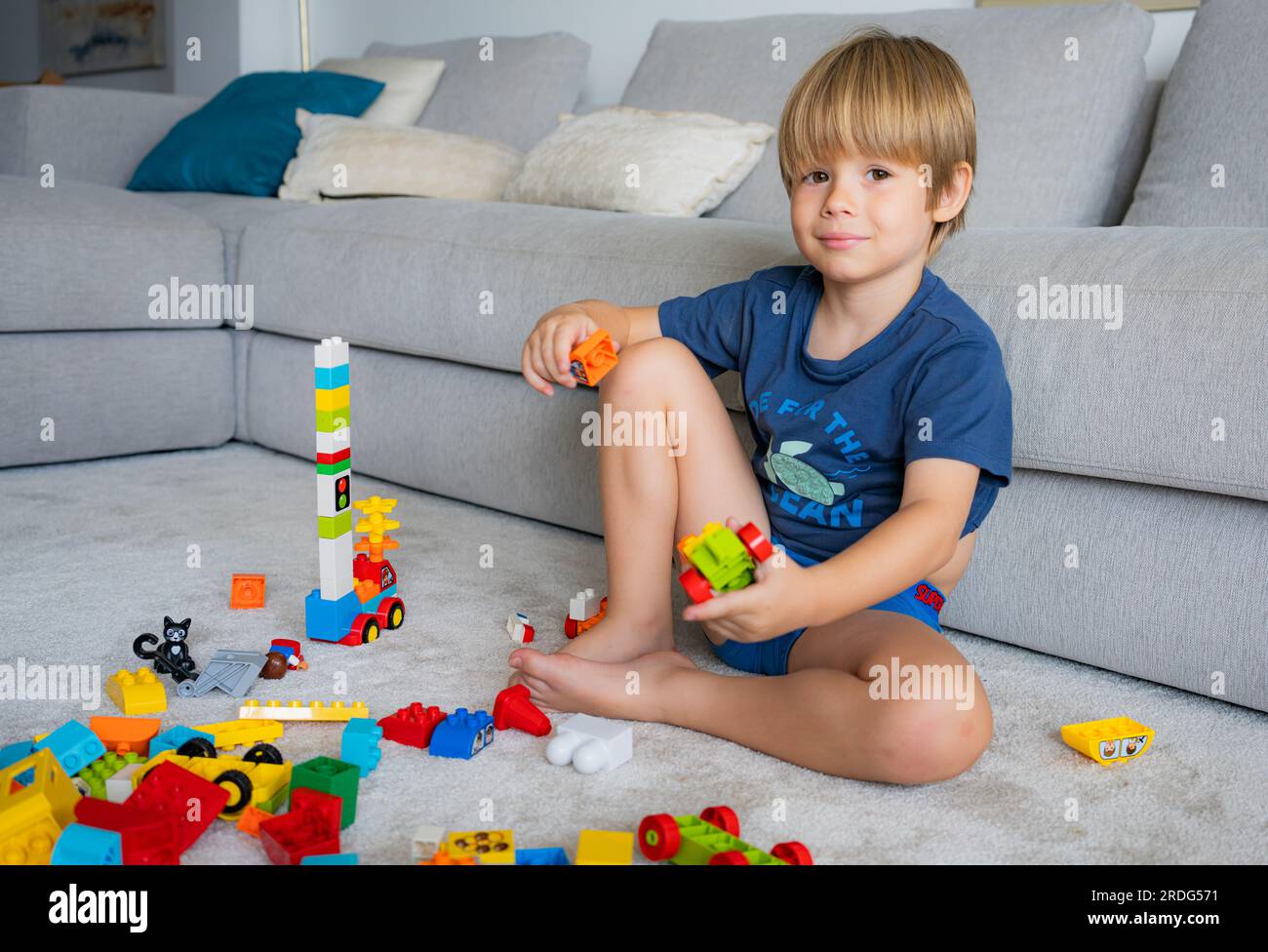 Kid playing with colorful toy blocks. Little boy building tower of ...