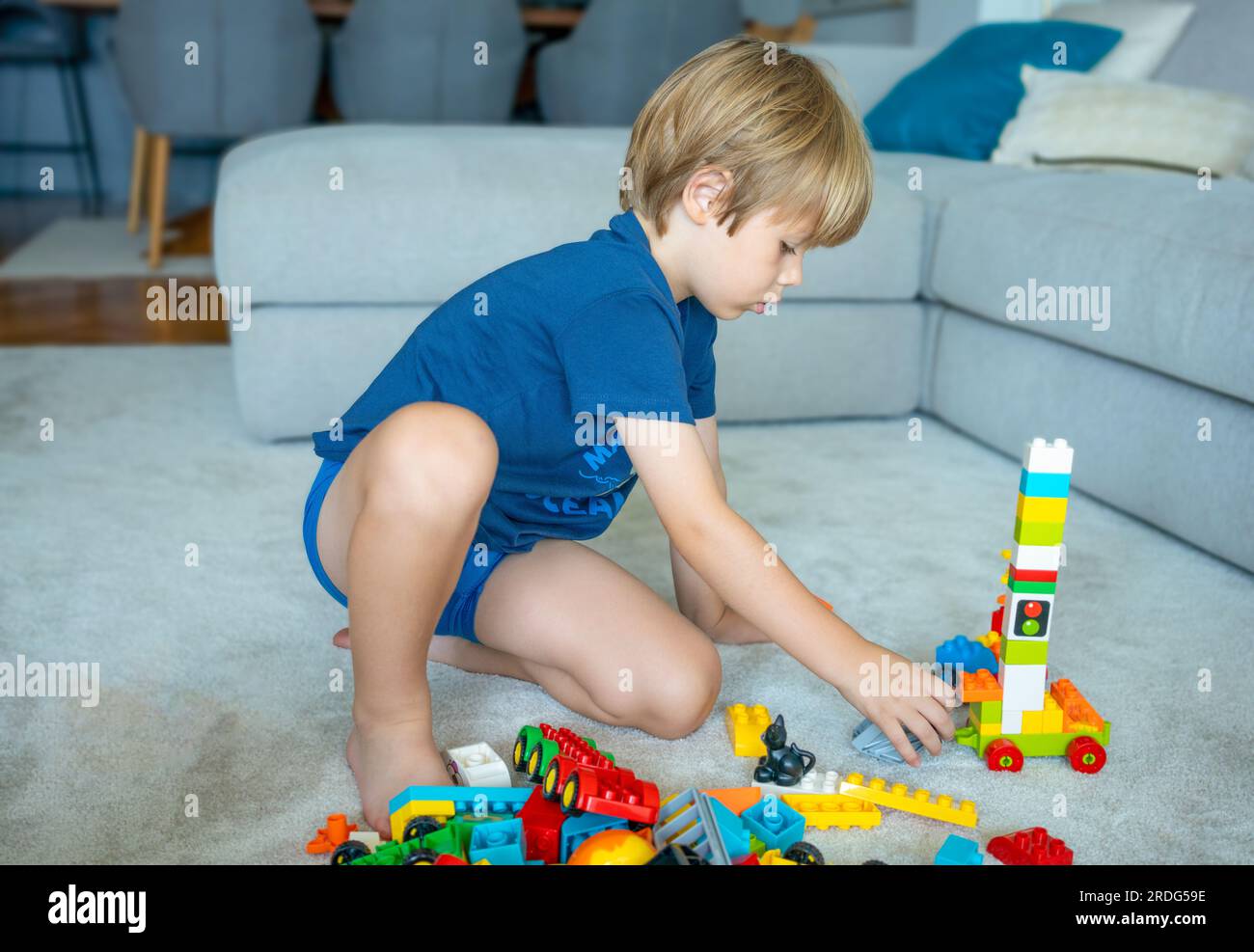 Kid playing with colorful toy blocks. Little boy building tower of ...
