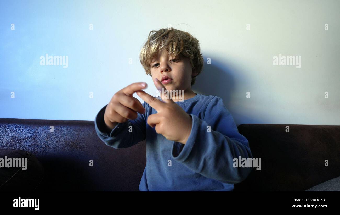 Little boy learning to count with fingers child development Stock Photo ...