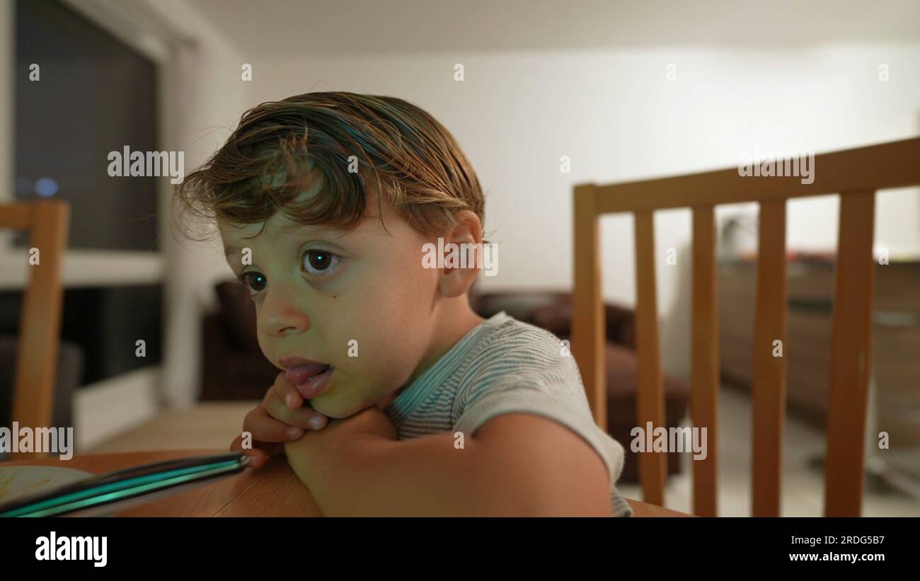 Little boy hypnotized by screen kid watching movie at home Stock Photo ...