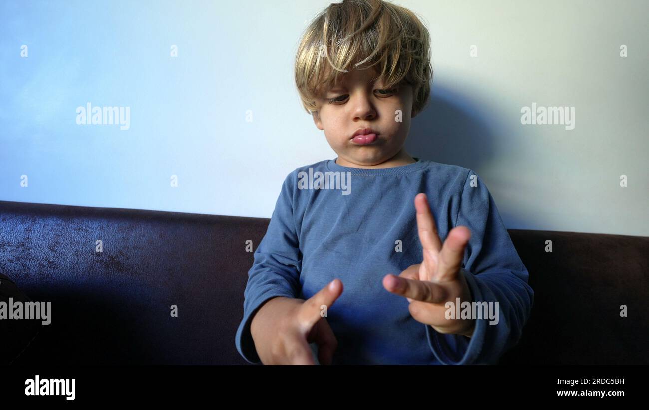 Little boy learning to count with fingers child development Stock Photo ...