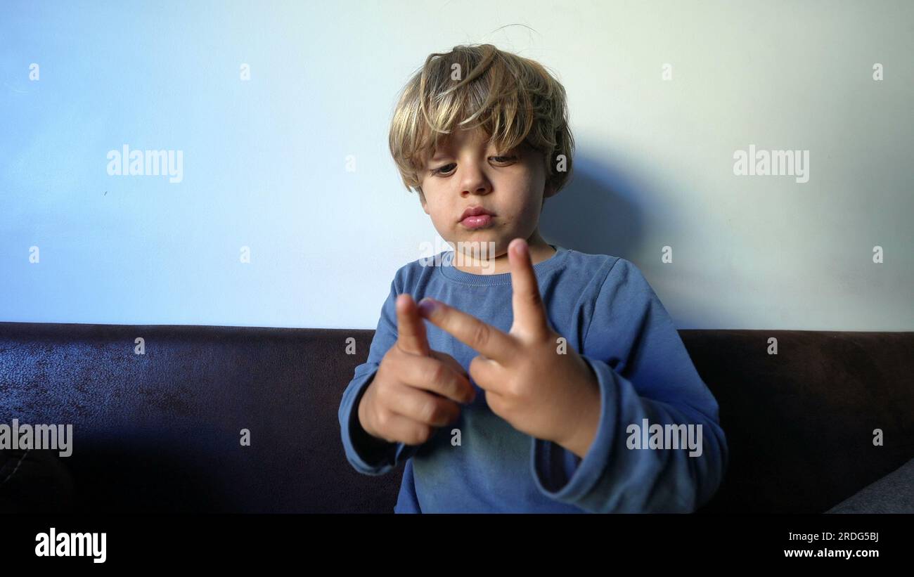 Little boy learning to count with fingers child development Stock Photo ...