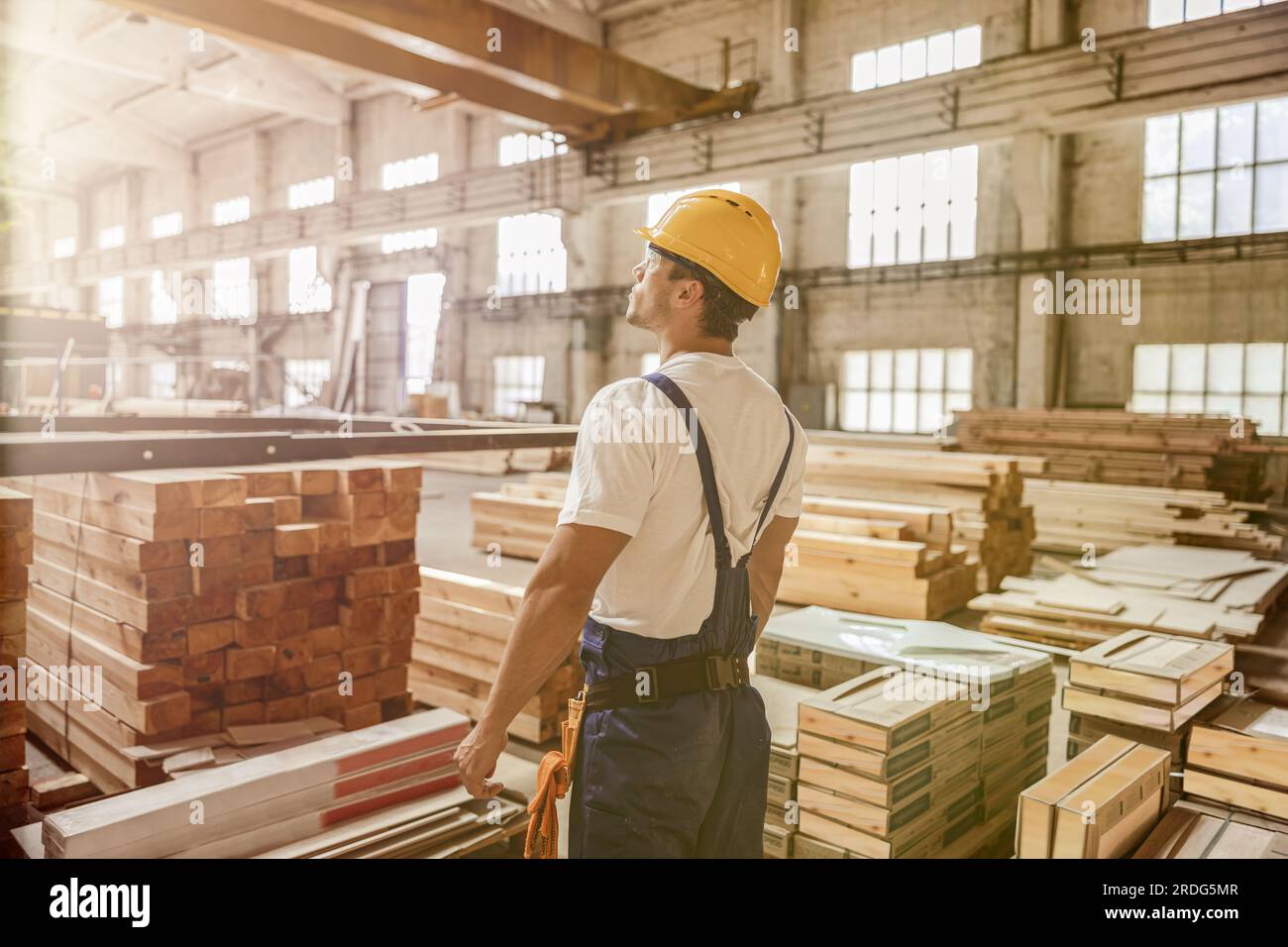 Male worker standing by construction materials in building Stock Photo ...
