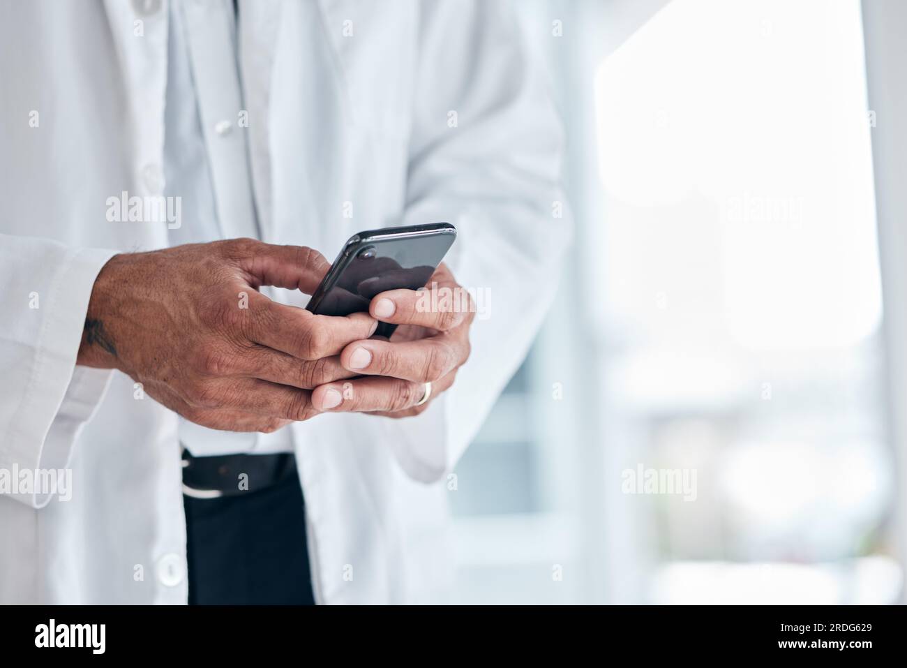 Phone, hands and doctor typing in hospital for research, telehealth and ...