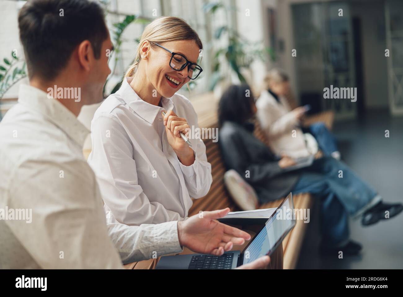 Woman office worker discussing new project with colleague during ...