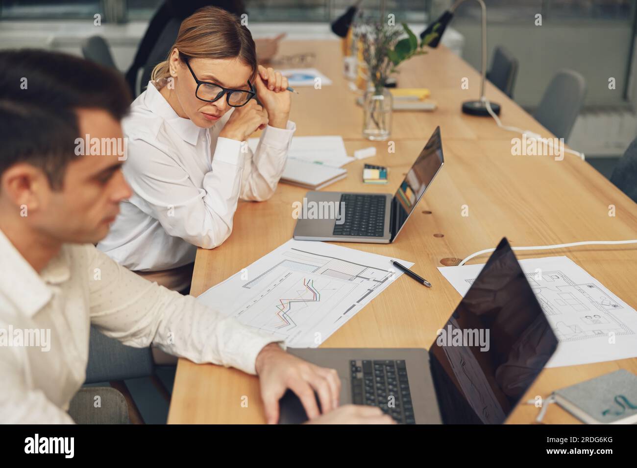 Two colleagues coworkers working together on new business plan during ...