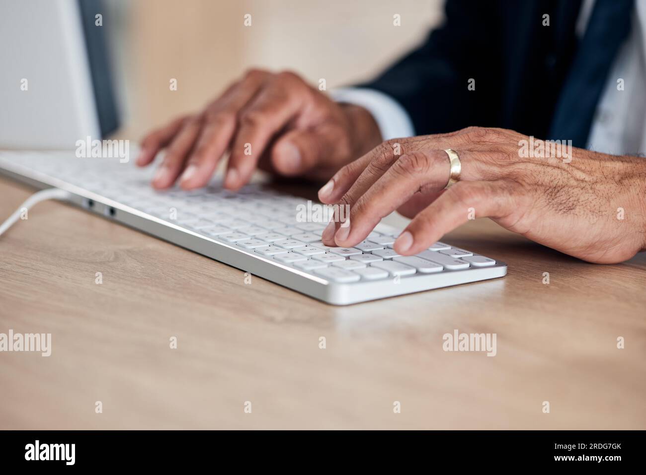 Hands, keyboard and a business man typing while working on a computer ...