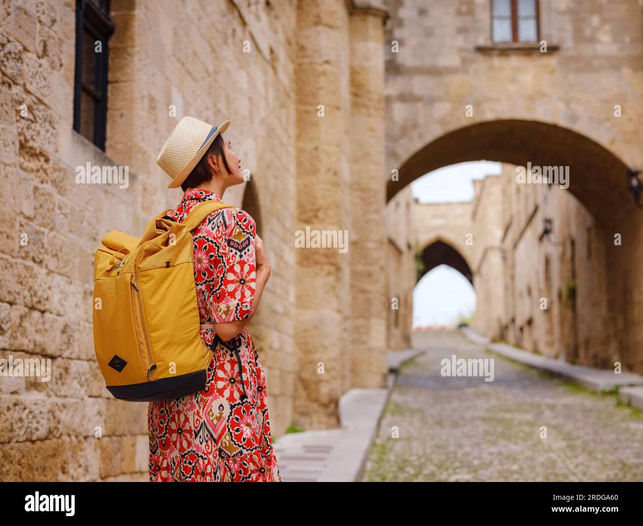 summer trip to Rhodes island, Greece. Young Asian woman in ethnic red ...