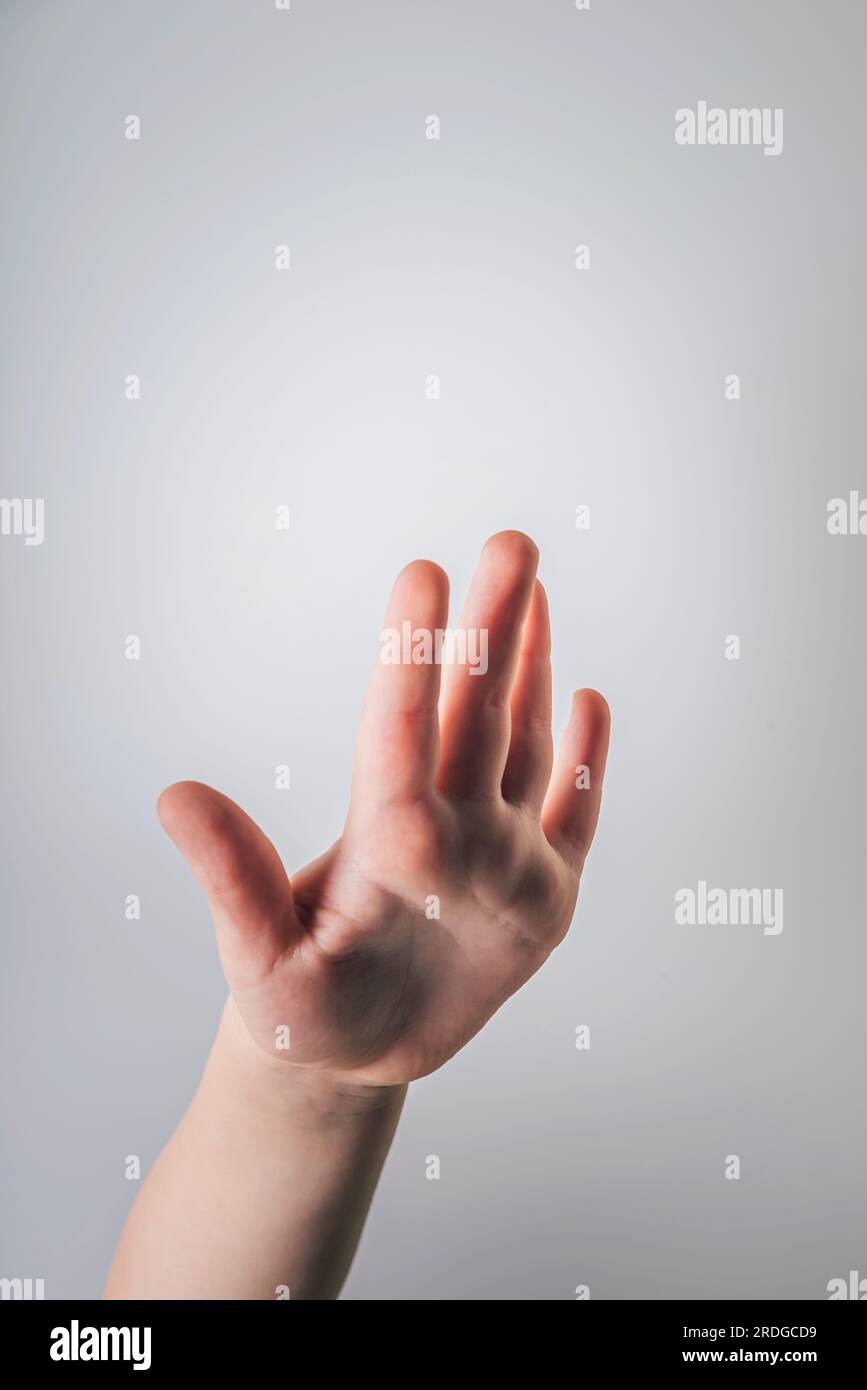 Child's hand stretches up on white background Stock Photo - Alamy