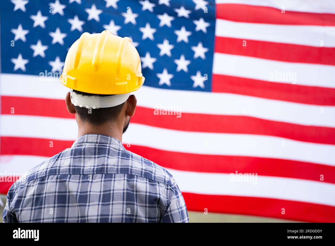 Rear view shot of Construction worker with safety helmet standing in ...