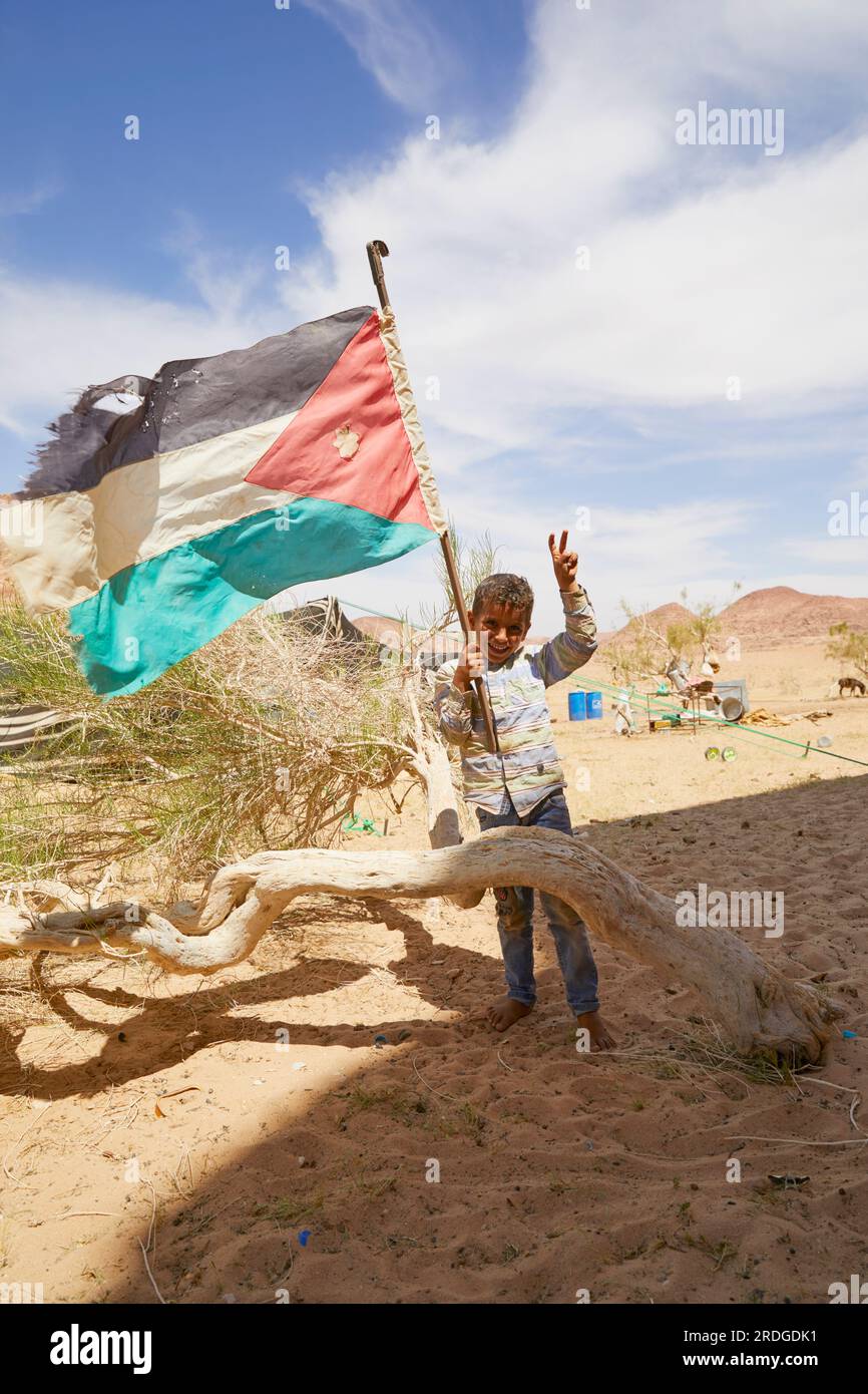 Bedouin boy holding up Jordanian flag, Wadi Rum, Aquaba, Jordan Stock ...
