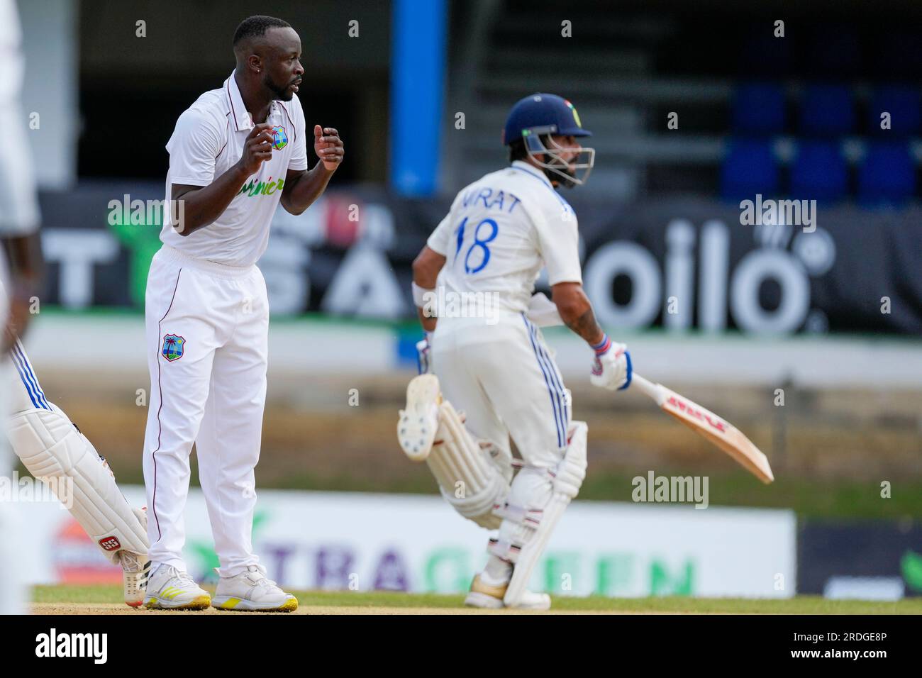 West Indies' bowler Kemar Roach gestures as India's Virat Kohli runs on ...