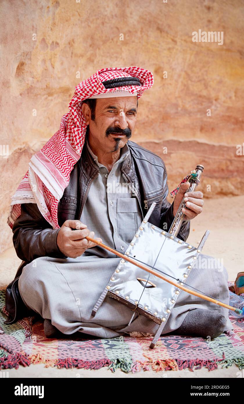 Man sat on floor playing Rababah, Petra, Ma'an Governorate, Jordan ...