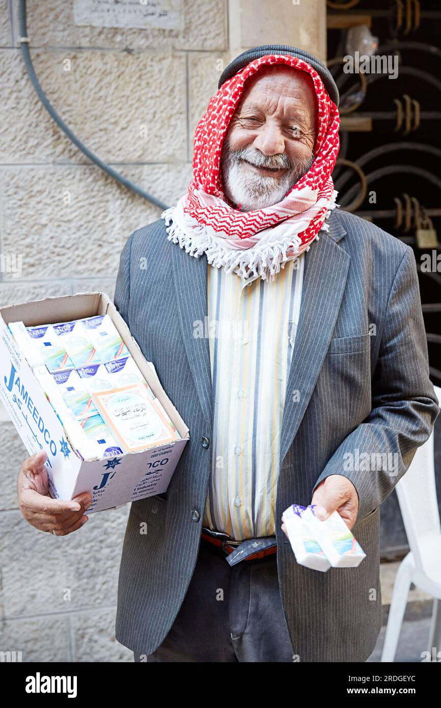 Portrait of old Jordanian man wearing Keffiyeh selling tissues on the ...