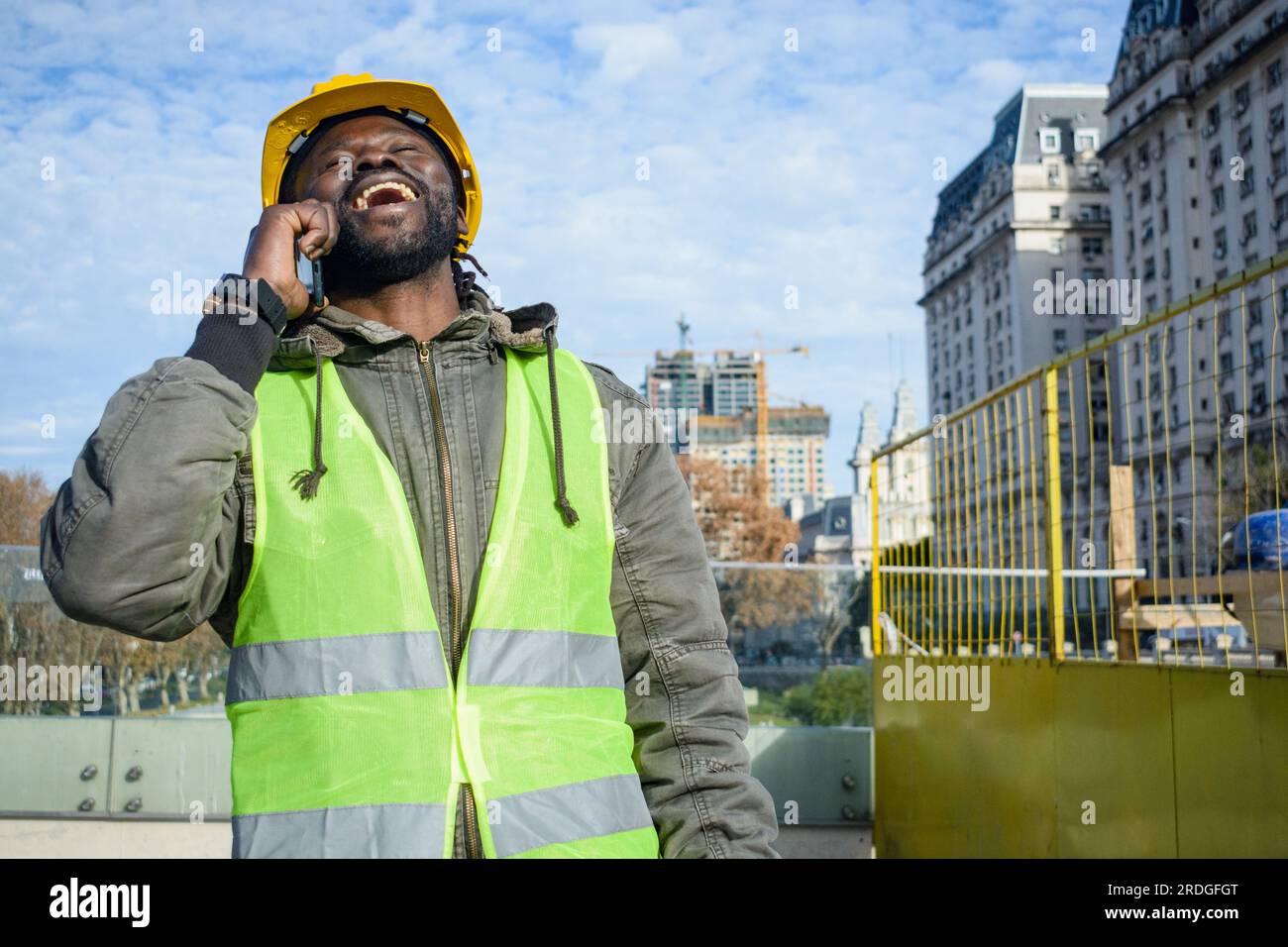 African ethnicity engineer man with a beard, wears a yellow safety ...