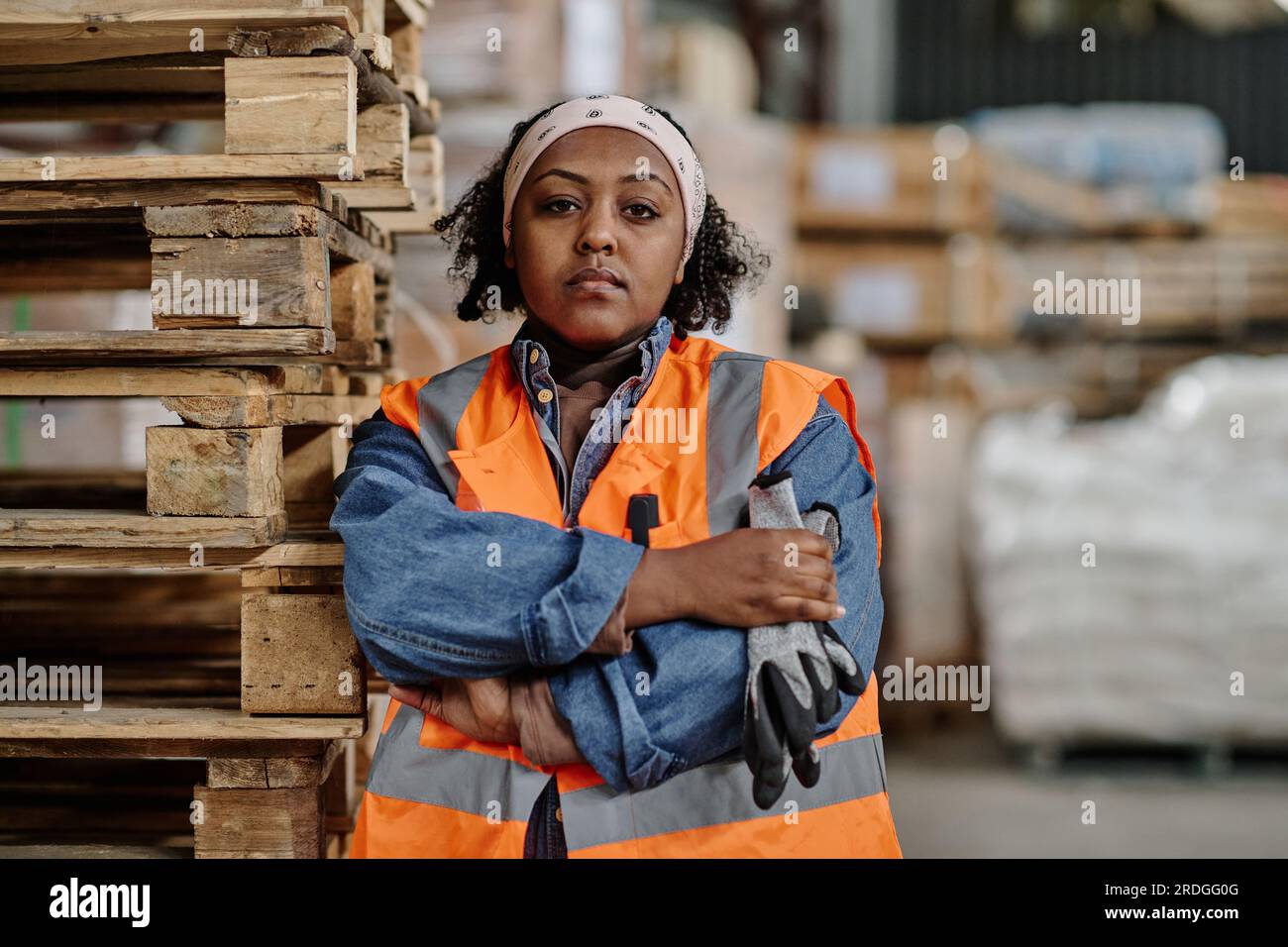 Portrait of young African American foreman looking at camera during her ...