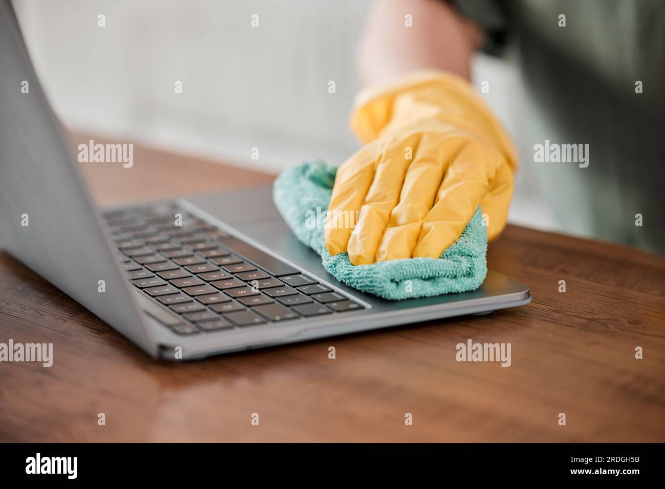 Person, hands and cleaning laptop for disinfection, bacteria or germ ...