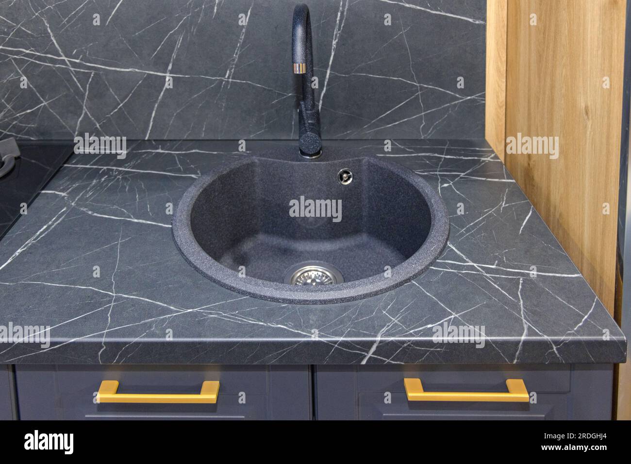 Round Black Kitchen Sink at Marble Style Counter Stock Photo - Alamy