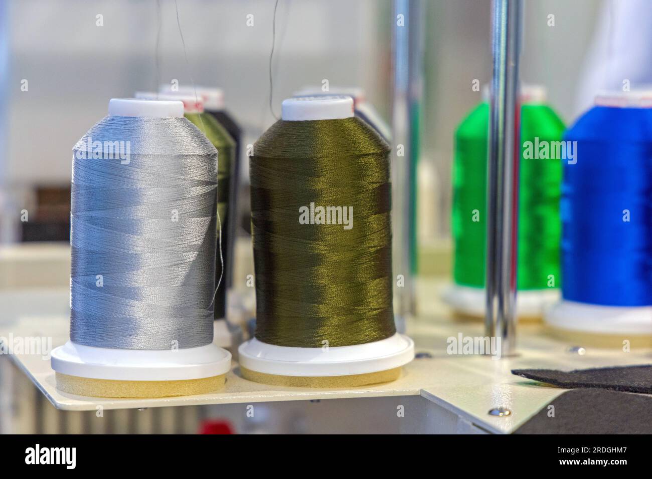 Thread Yarn Spools at Sewing Machine in Garment Factory Stock Photo - Alamy