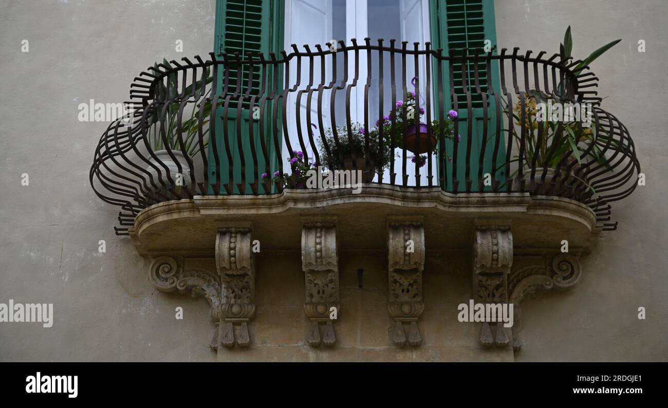 Antique house Rococo style facade with green wooden window shutters and ...