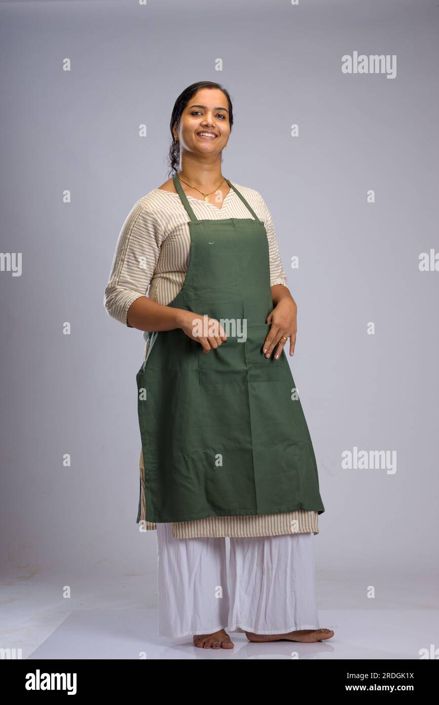 Indian women chef, potrait of a lady wearing apron with white ...