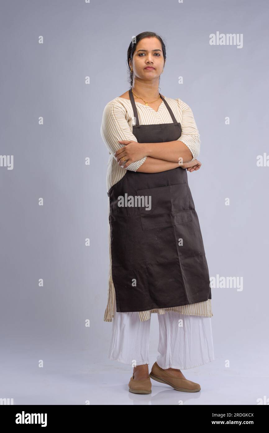 Indian women chef, potrait of a lady wearing apron with white ...