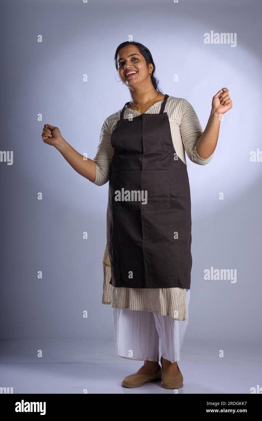 Indian women chef, potrait of a lady wearing apron with white ...