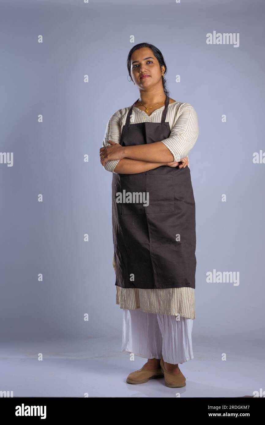 Indian women chef, potrait of a lady wearing apron with white ...