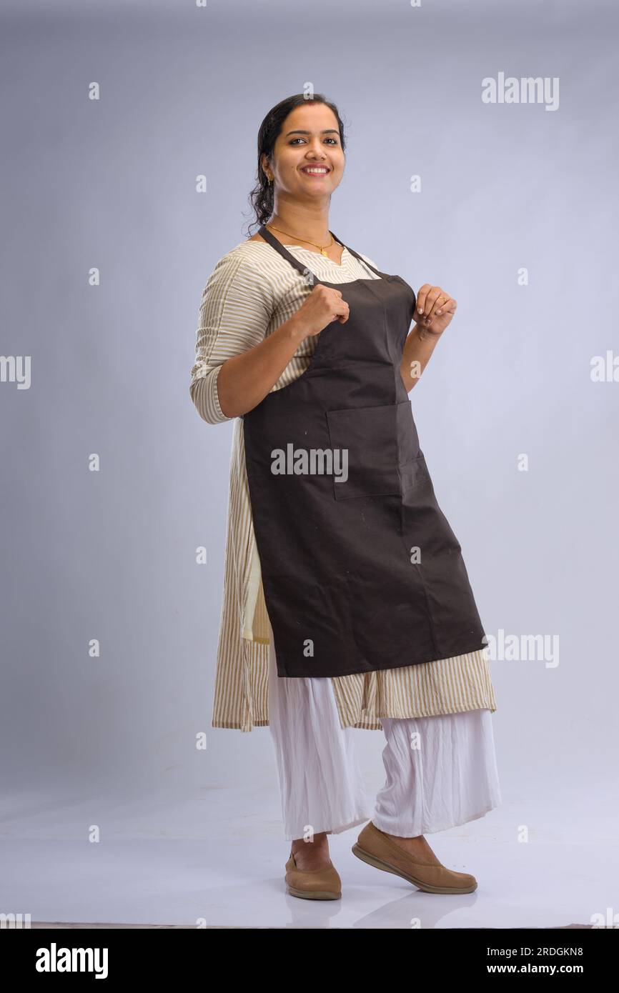 Indian women chef, potrait of a lady wearing apron with white ...