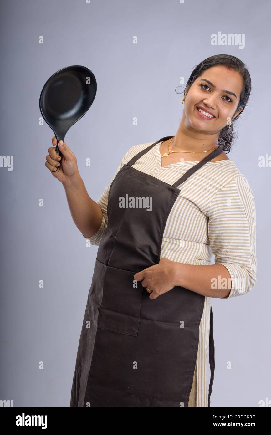 Indian women chef, potrait of a lady wearing apron with white ...