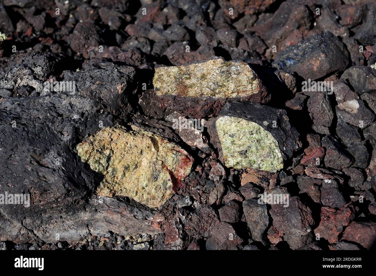 Olivine nodules on basaltic rocks. Olivine is a mineral composed by ...