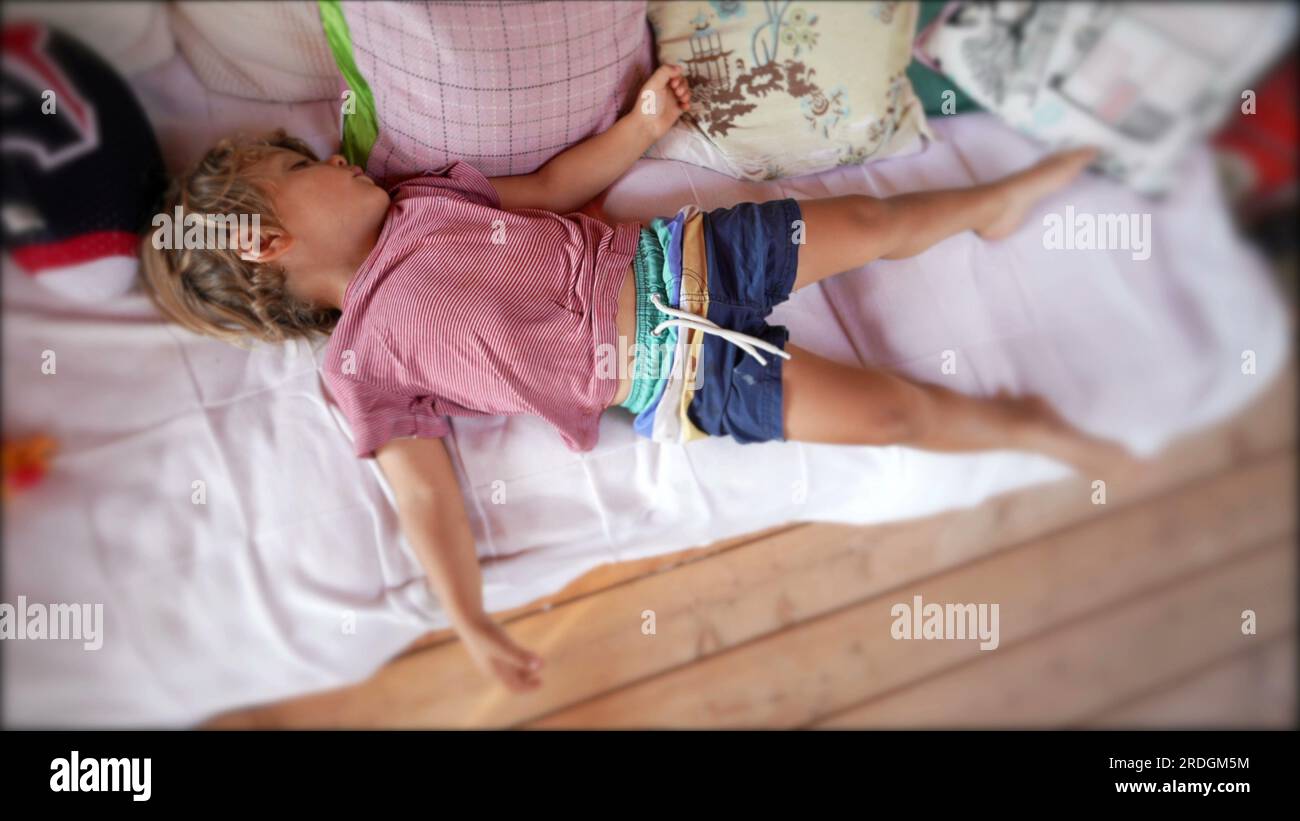 One small boy napping in the afternoon lying on couch Stock Photo - Alamy
