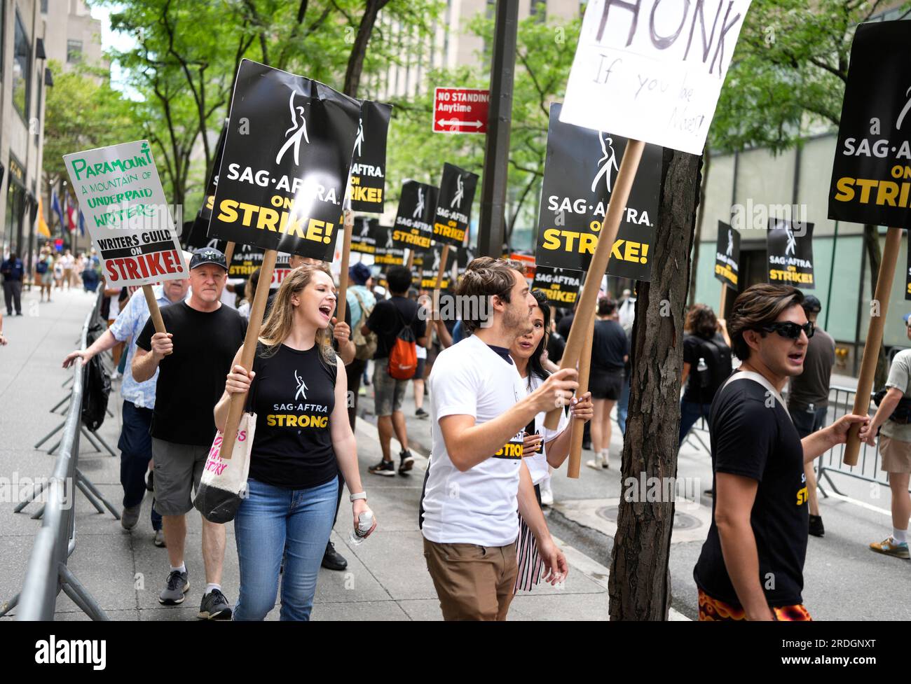 Picketers carry signs outside NBC in Rockefeller Center on Friday, July ...
