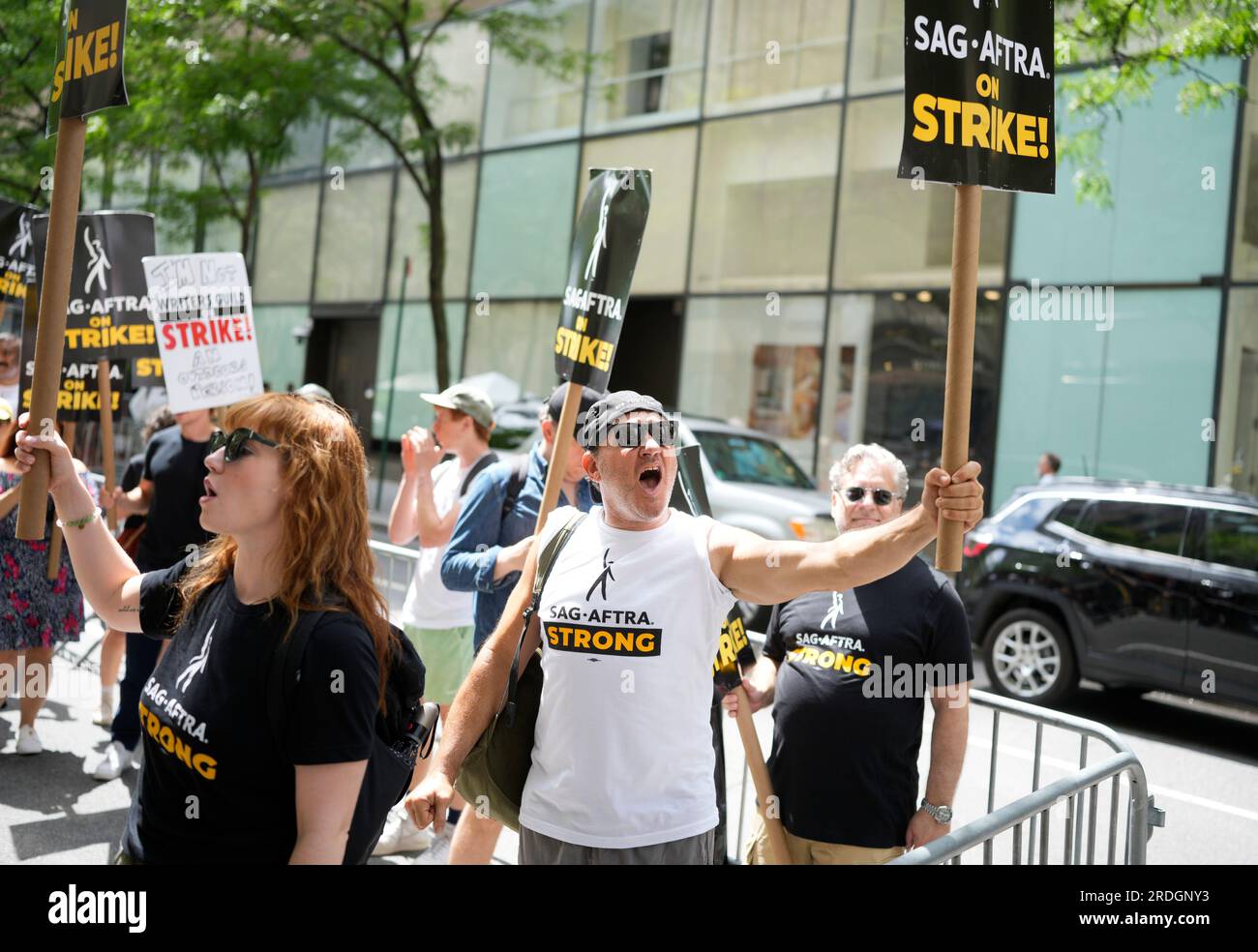 Picketers carry signs outside NBC in Rockefeller Center on Friday, July ...