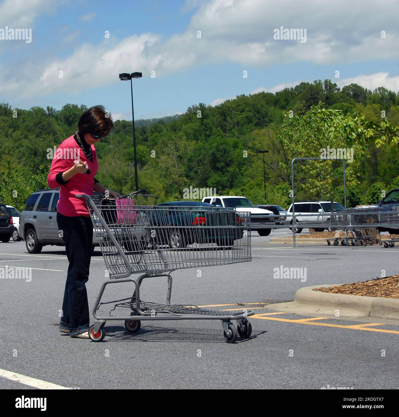 Mature and attractive woman checks her purse and keys as she pushes a ...