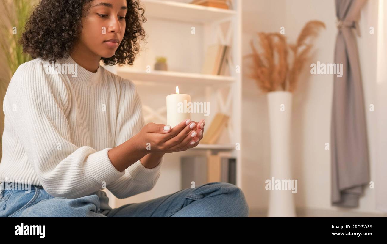 Candle meditation all souls day woman praying home Stock Photo - Alamy
