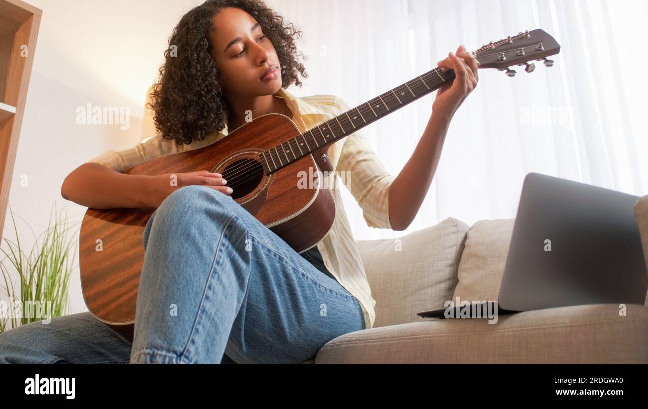Guitar hobby music practice woman chords home Stock Photo - Alamy