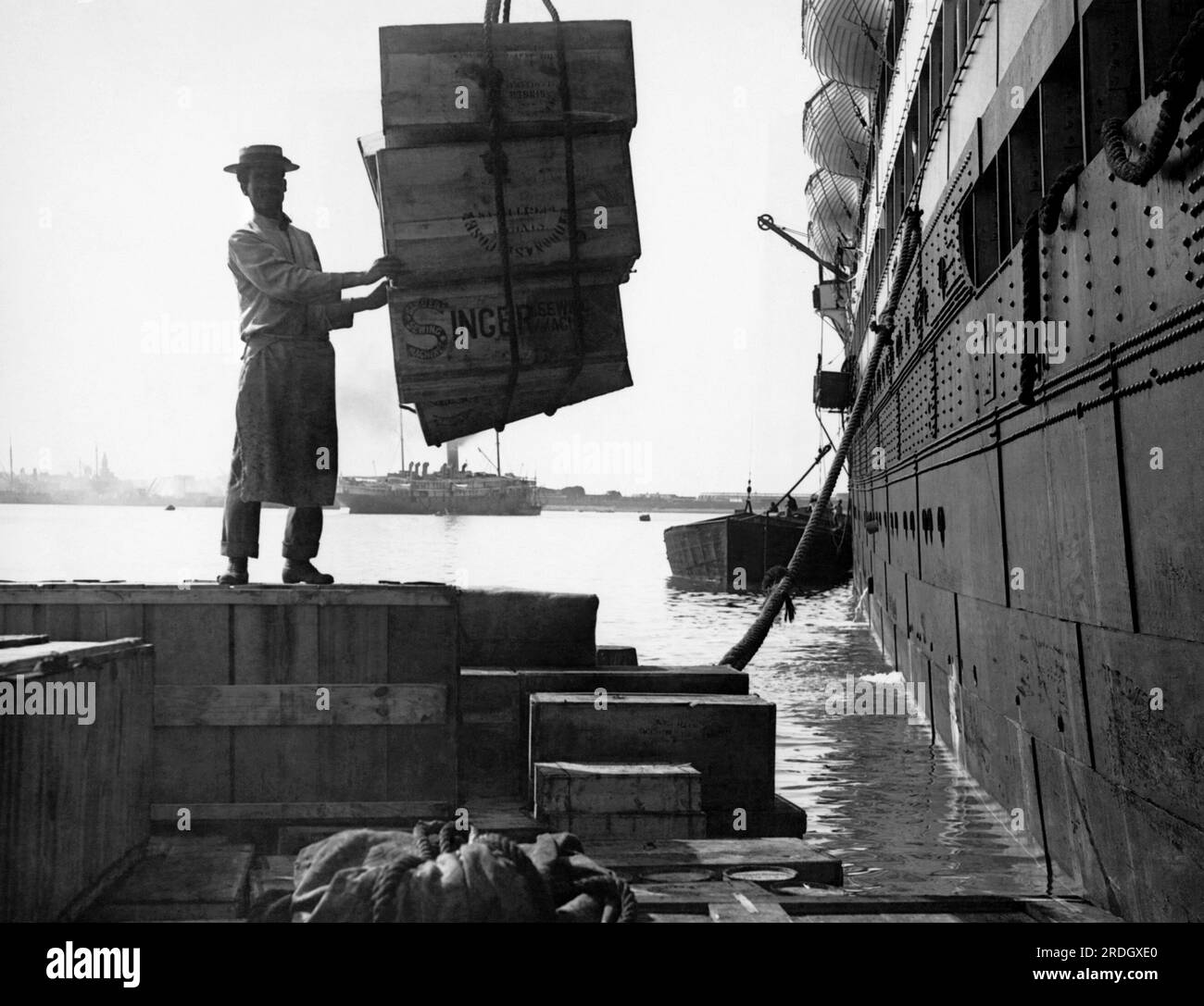 Peru: c. 1924 Unloading cases of Singer sewing machines from a cargo ...