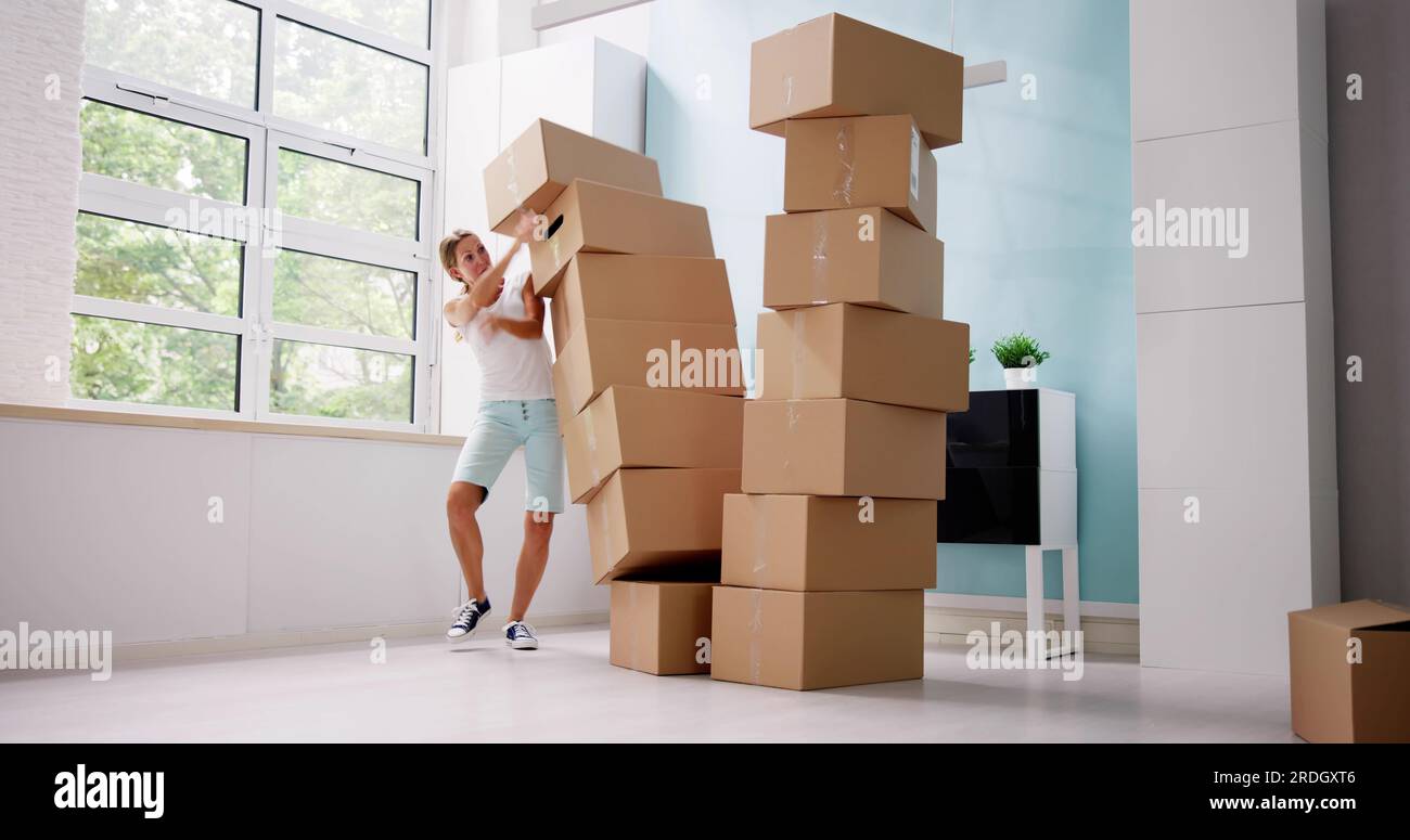 Funny Moving Accidents. Falling Cardboard Boxes At Home Stock Photo - Alamy