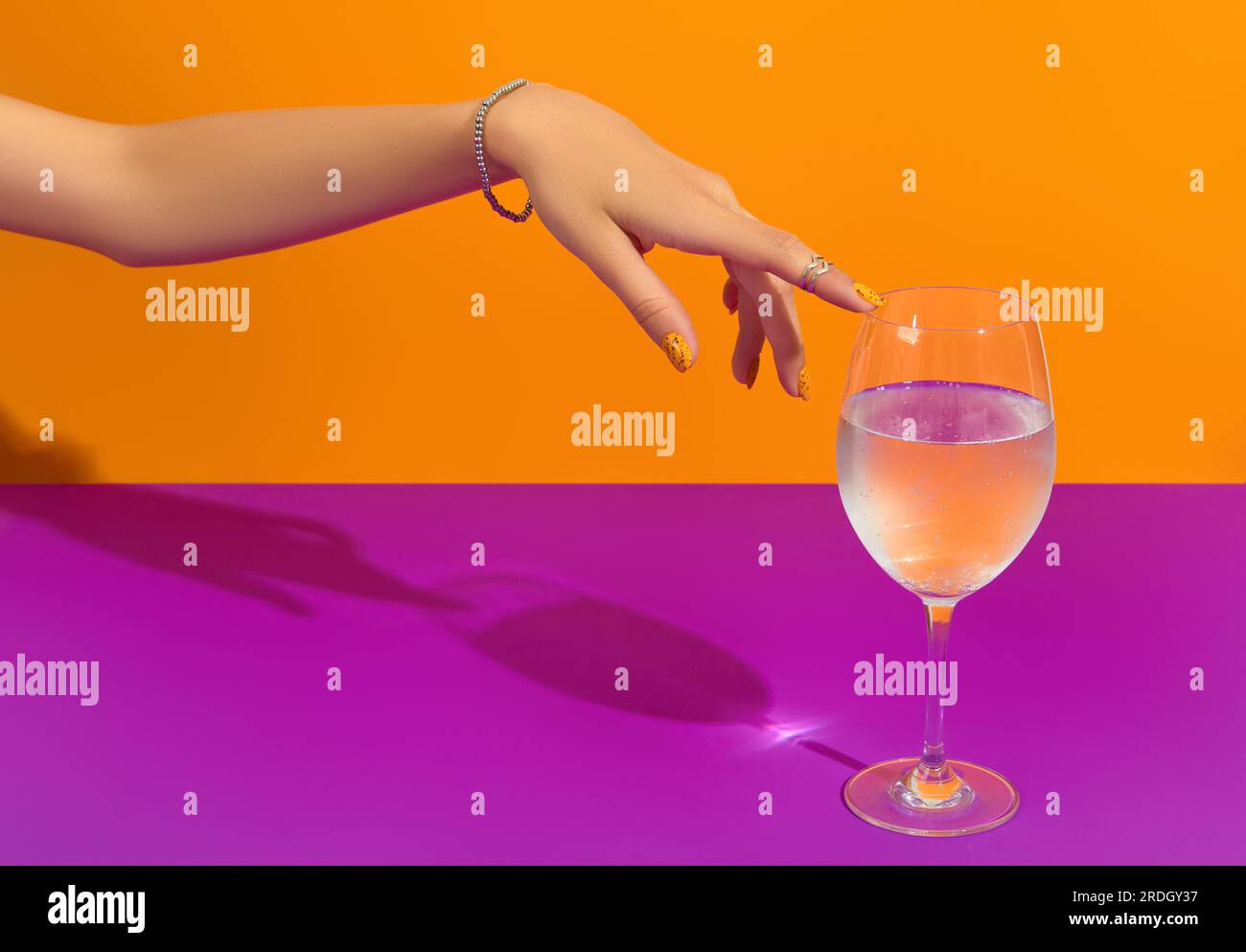 Womans hand touch glass on pink background. Manicure design trends ...