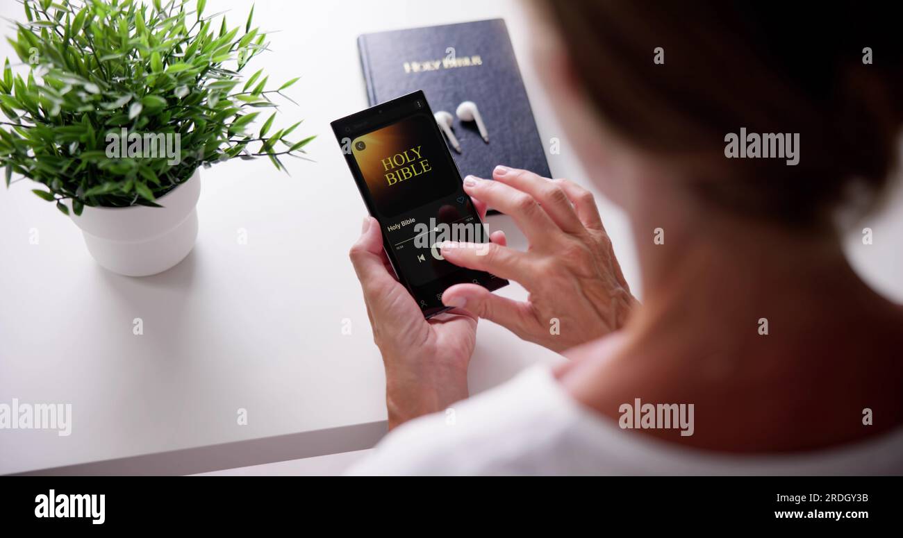 Christian Woman Reading Bible Book On Phone And Praying Stock Photo - Alamy