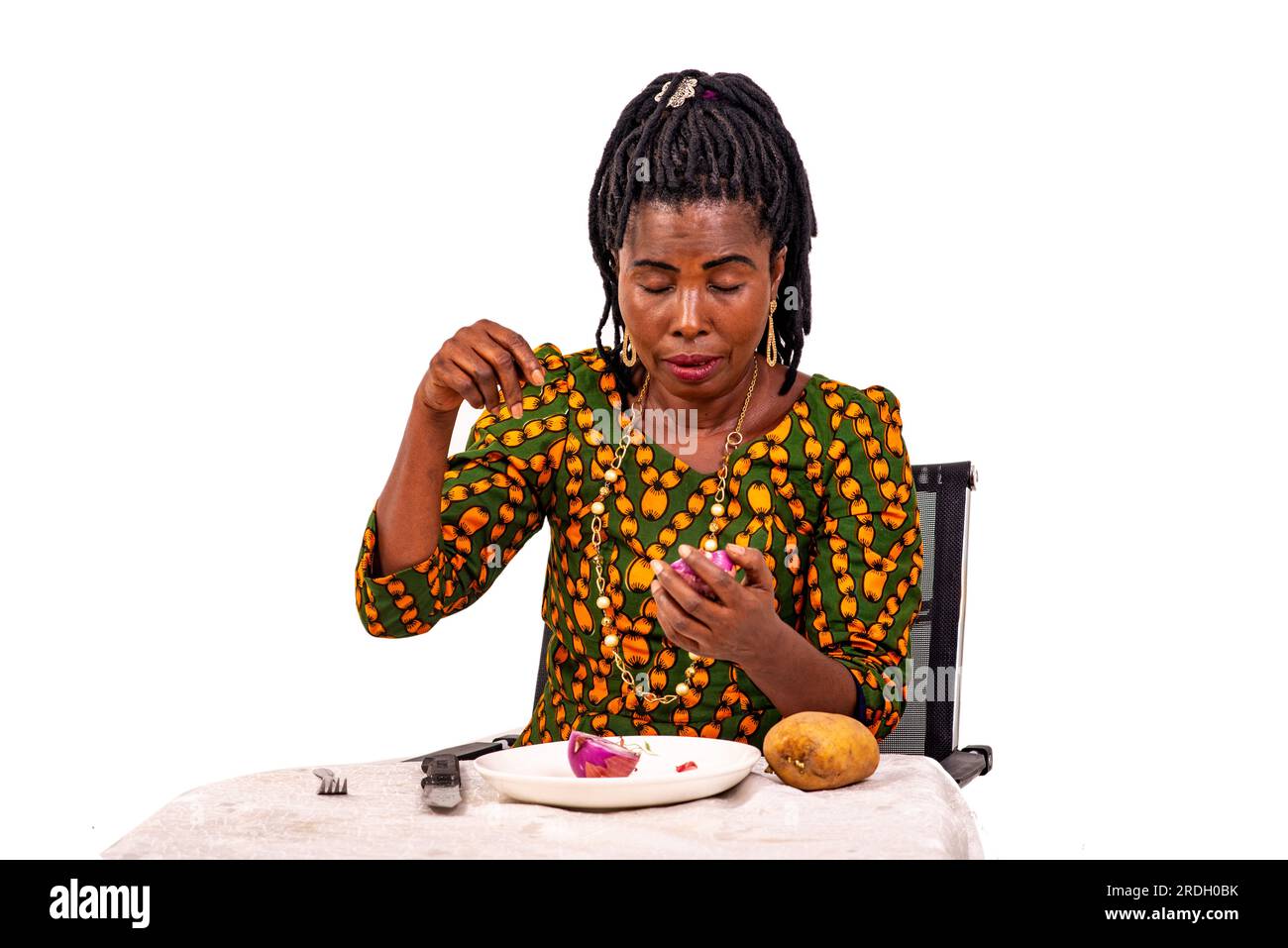 portrait of a beautiful adult housewife crying while cutting purple ...