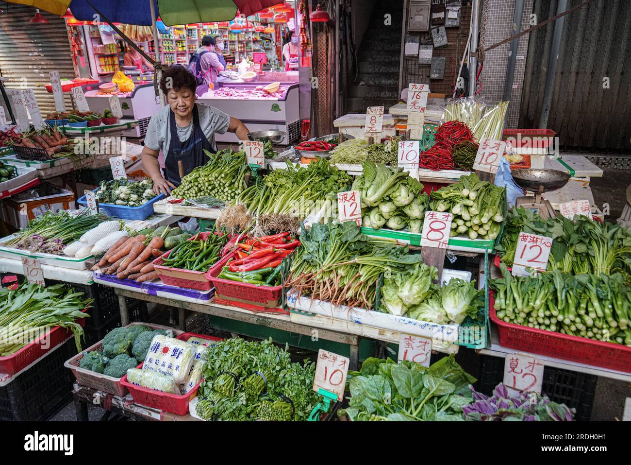 Hong Kong, China. 07th July, 2023. A woman sells vegetable at a market ...