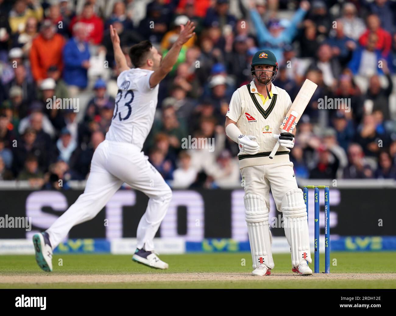 England's Mark Wood (left) celebrates the wicket of Australia's Travis ...