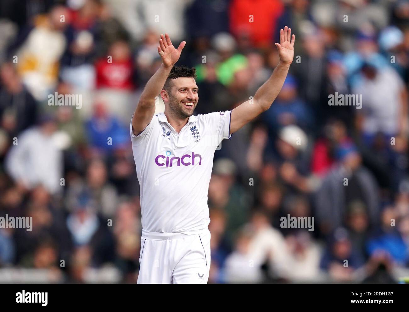 England's Mark Wood celebrates the wicket of Australia's Travis Head ...