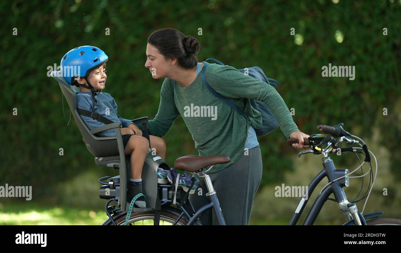 Mother and child loving moment together riding bicycle kid sitting on ...
