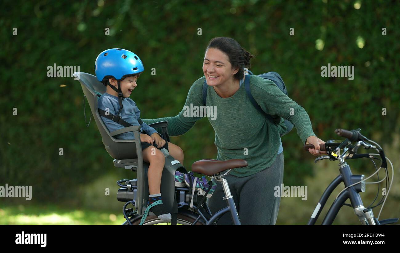Mother and child loving moment together riding bicycle kid sitting on ...