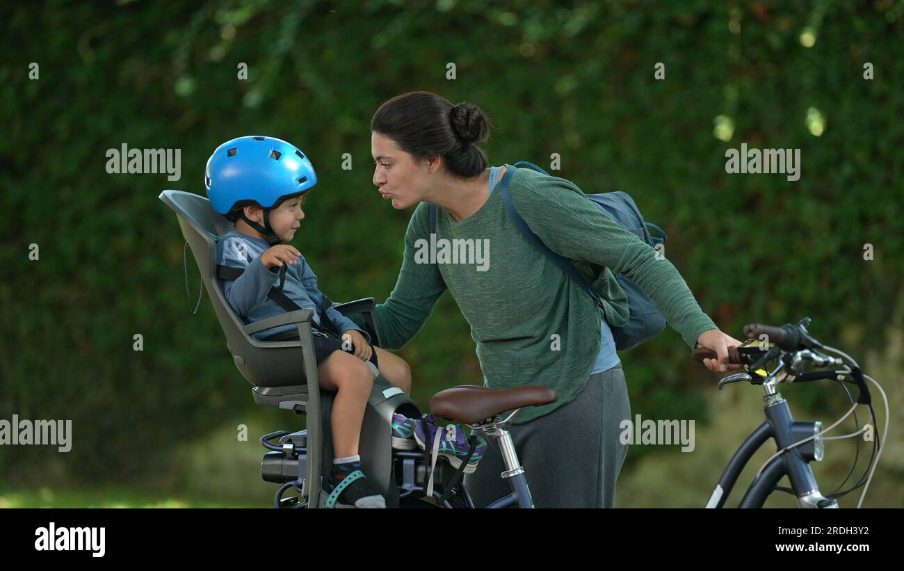 Mother and child loving moment together riding bicycle kid sitting on ...