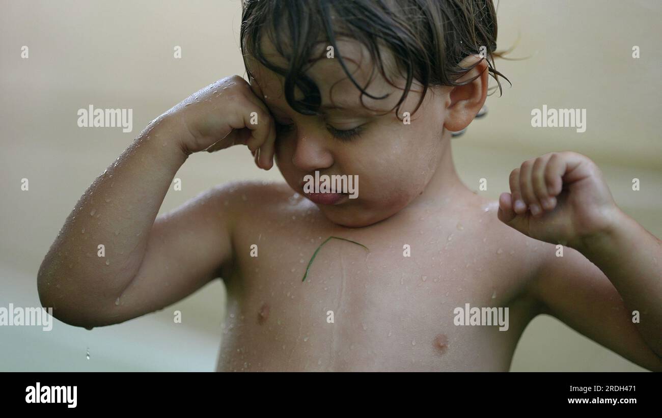 Tired little boy rubbing eyes child feeling exhausted from play Stock ...